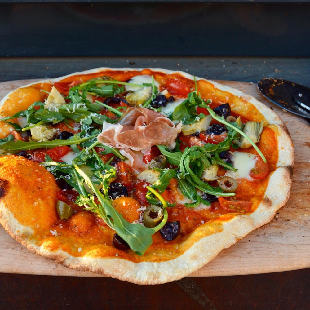 Pizza baking in a wood fired oven | Kitchenroots